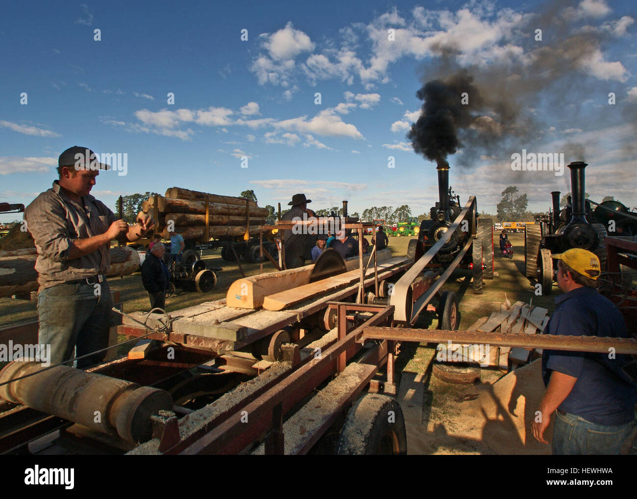 A country fair featuring old-style farming equipment, including a ...