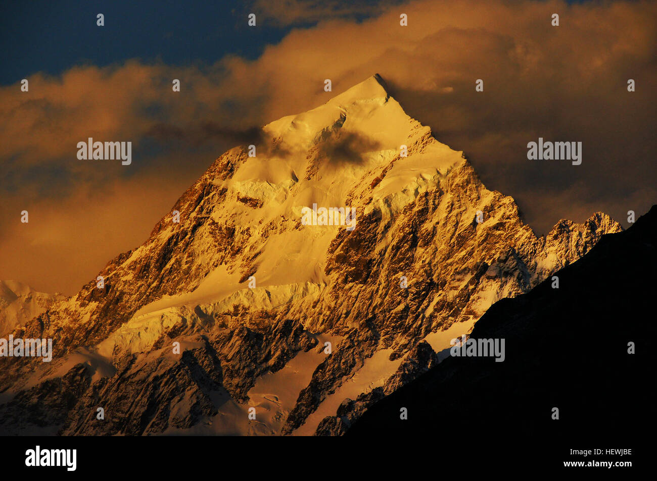 Aoraki/Mount Cook, New Zealand's highest peak, is illuminated at dawn ...