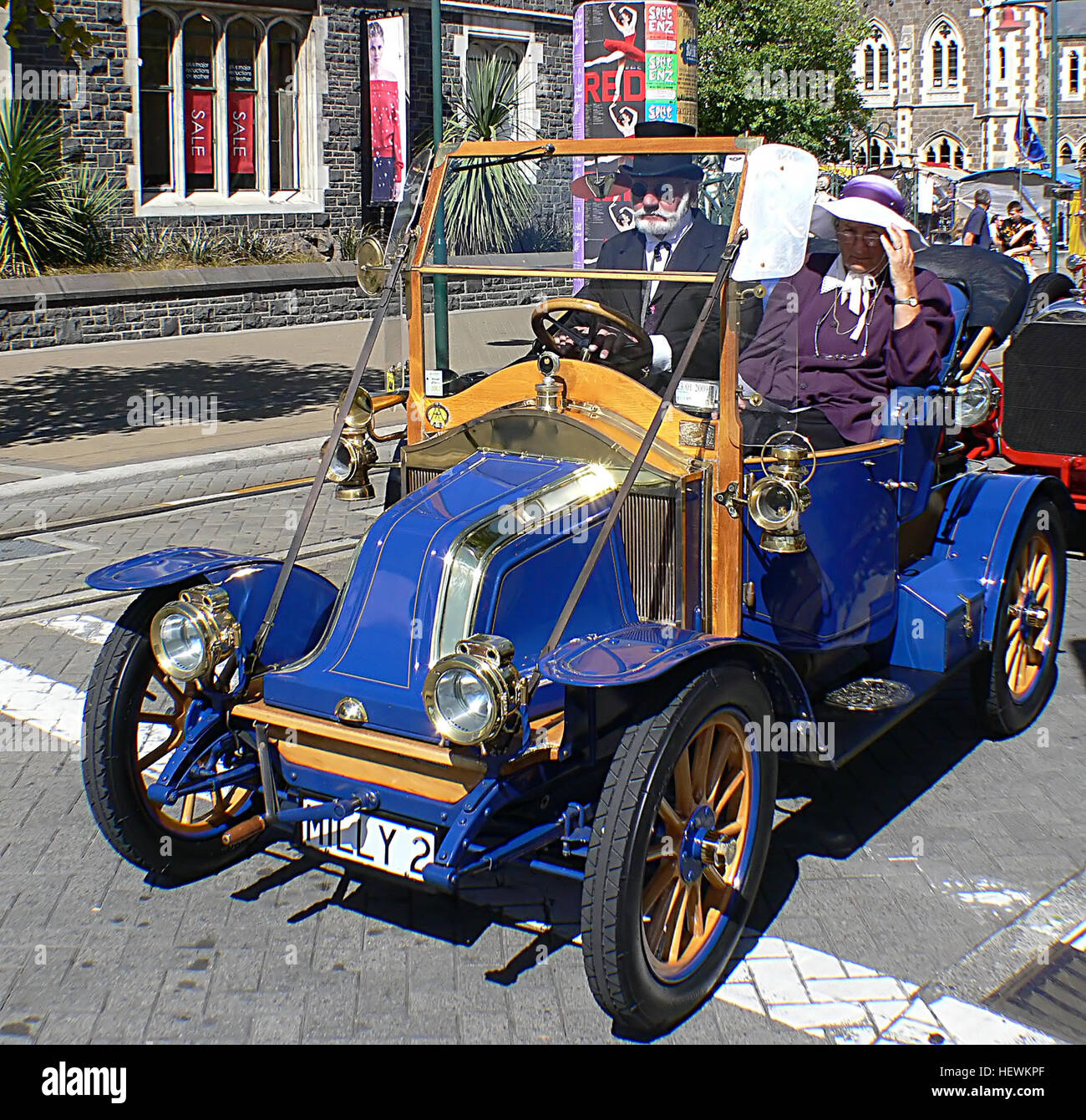 This photograph showcases a vintage blue Renault car displayed at a car ...