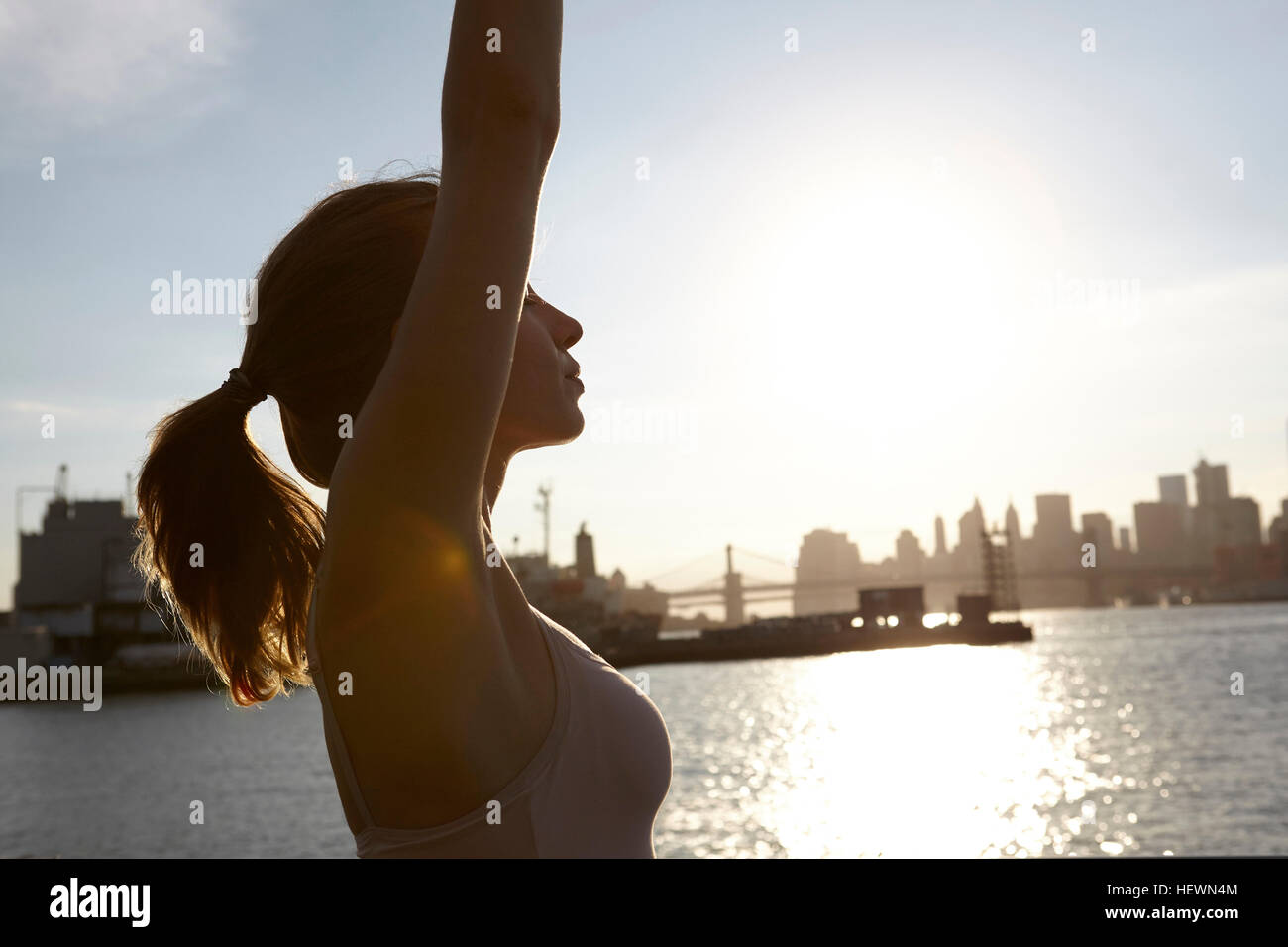 Woman with arms up side view hi-res stock photography and images - Alamy