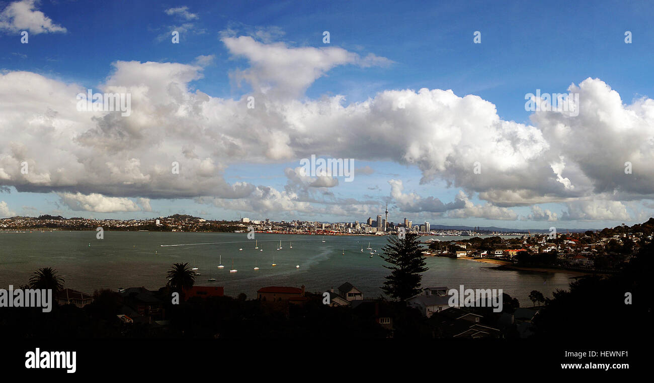 A scenic view of Auckland Harbour with the Devonport ferry docked and a ...
