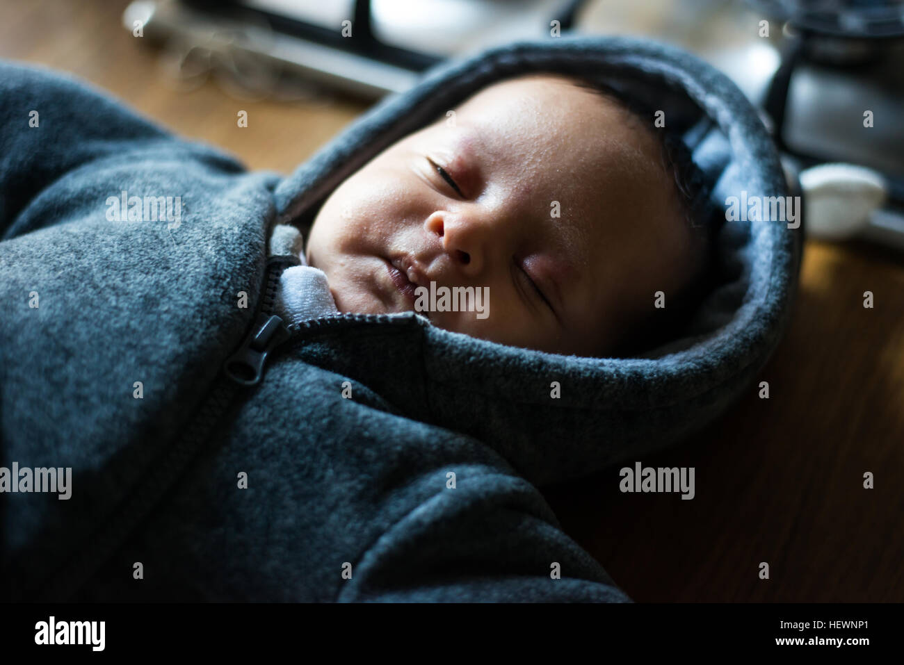 Newborn baby sleeping on a kitchen bar Stock Photo - Alamy