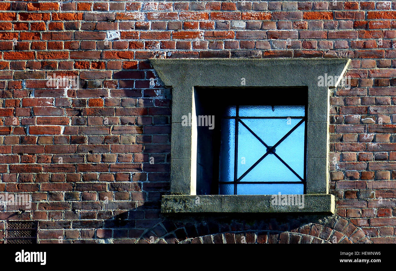 This image showcases a brick wall with a window, photographed with a ...