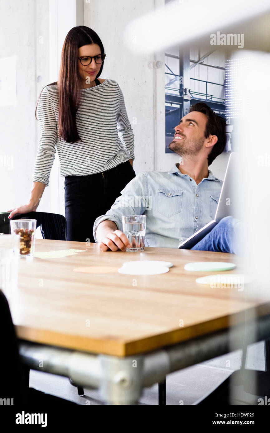 Colleagues in office using laptop Stock Photo - Alamy