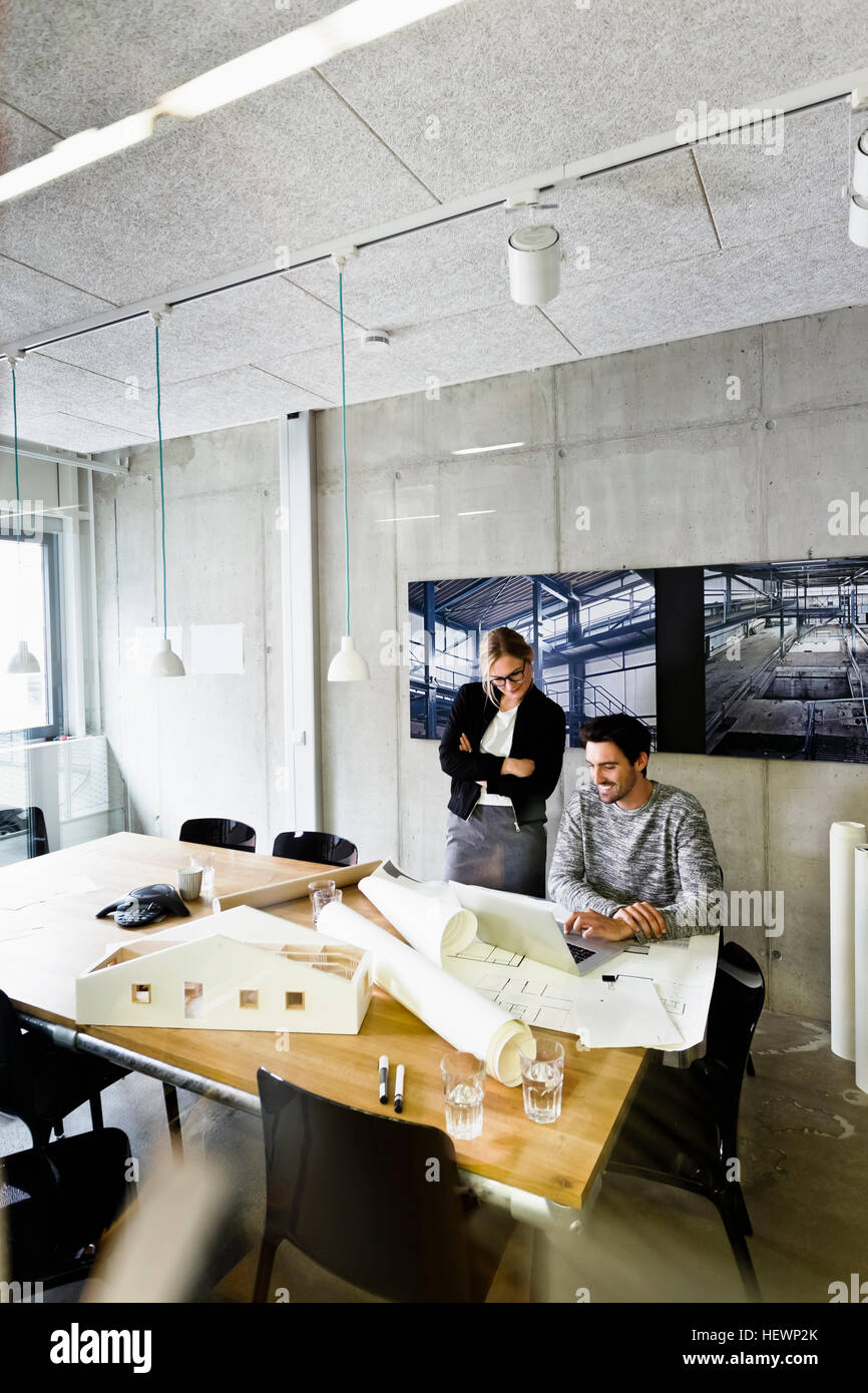 Colleagues in conference room using laptop Stock Photo - Alamy