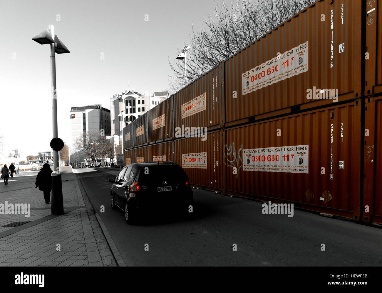 A wall of containers stand along the south side of Christ Church ...