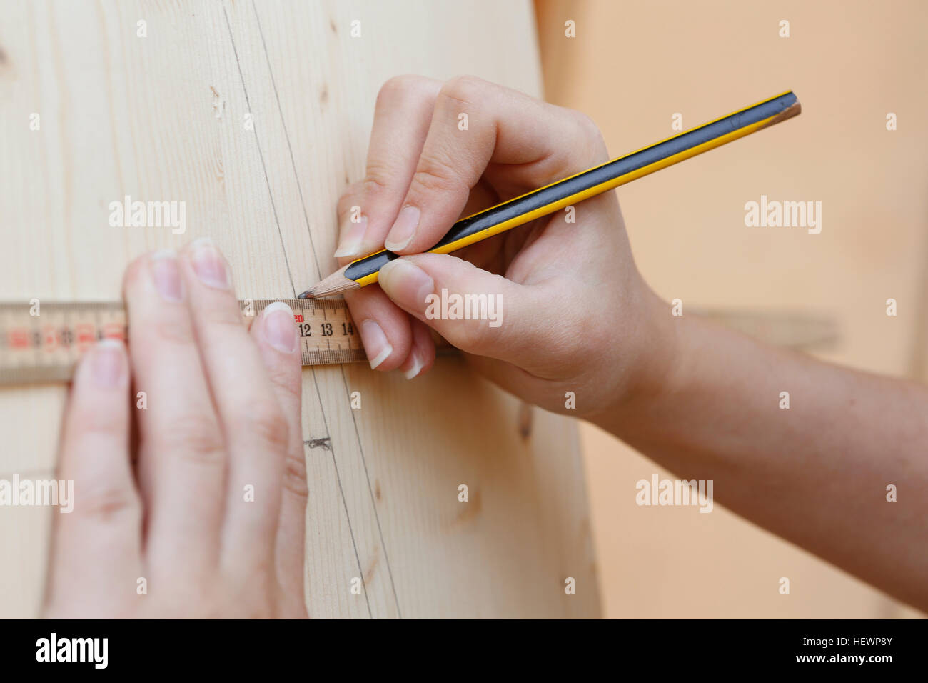 Cropped view of woman measuring timber Stock Photo - Alamy