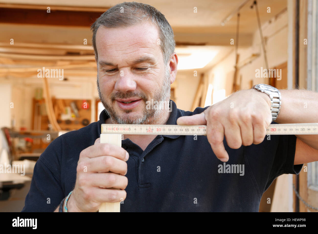 Man measuring timber Stock Photo - Alamy