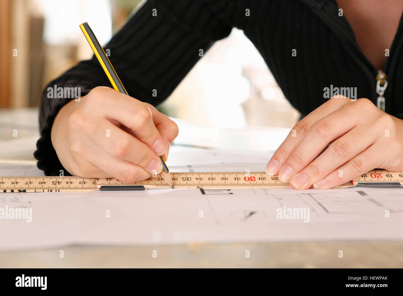 Cropped view of woman drawing blueprint Stock Photo - Alamy