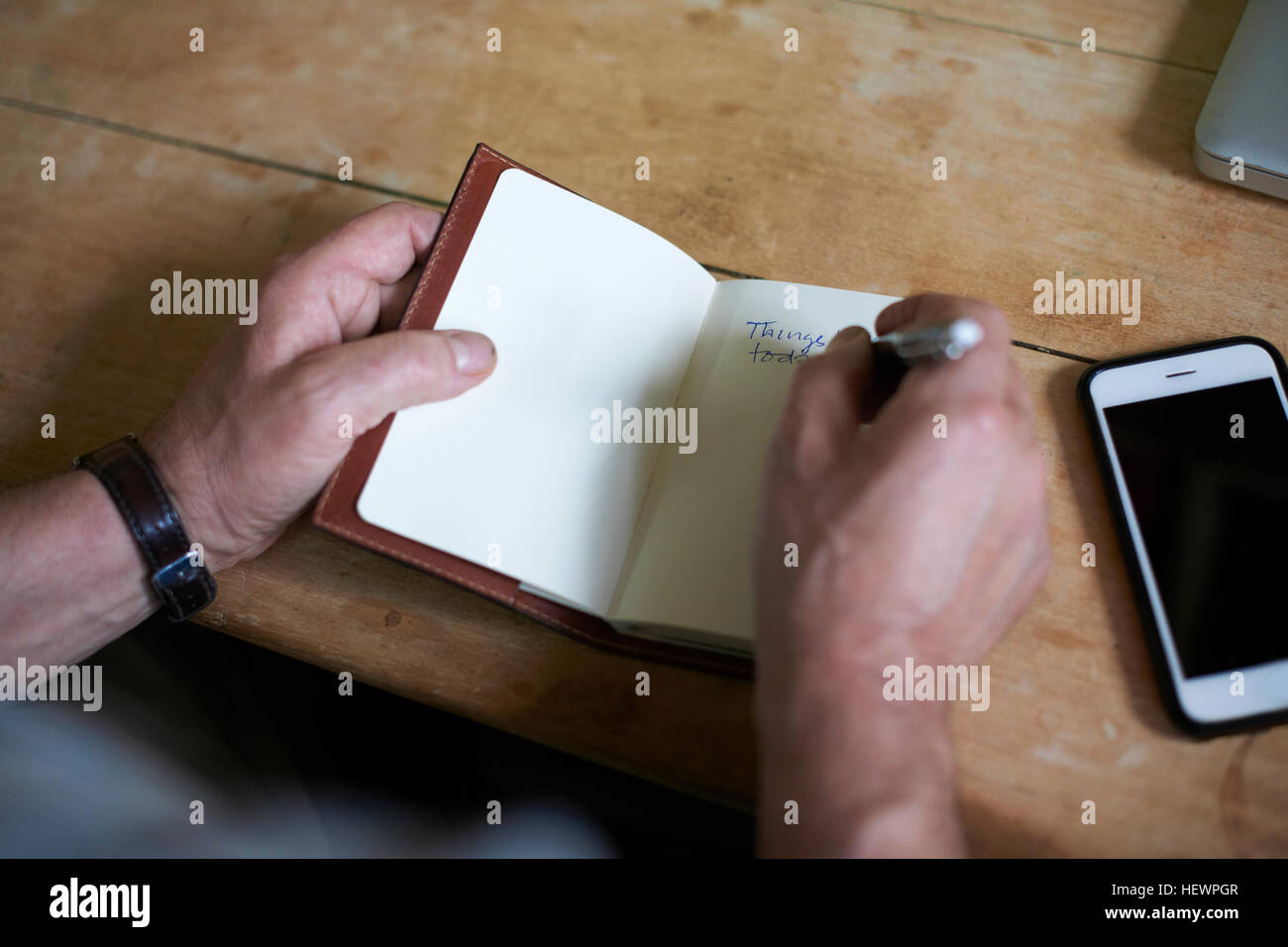 Man writing in notebook, close-up Stock Photo - Alamy