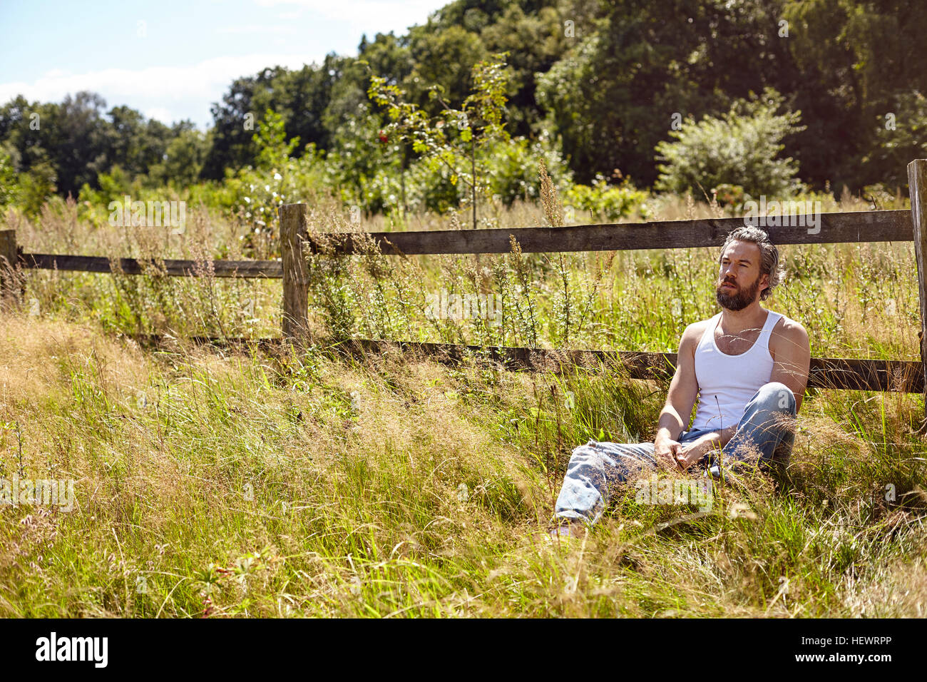 Man Leaning Against Fence High Resolution Stock Photography and Images ...