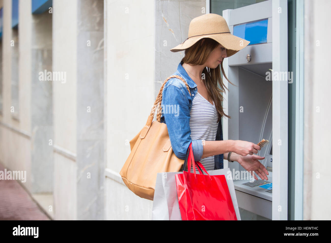 Woman withdrawing money from cash machine hi-res stock photography and ...