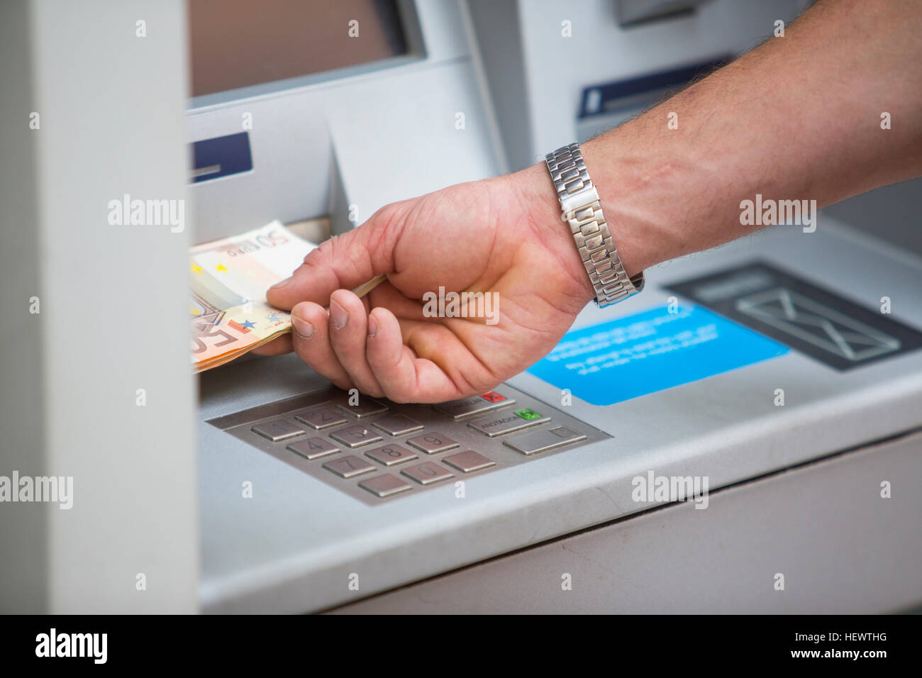 Man withdrawing money hi-res stock photography and images - Alamy