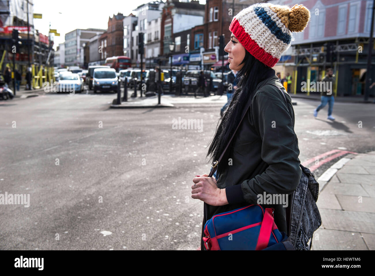 Young woman crossing city street Stock Photo - Alamy