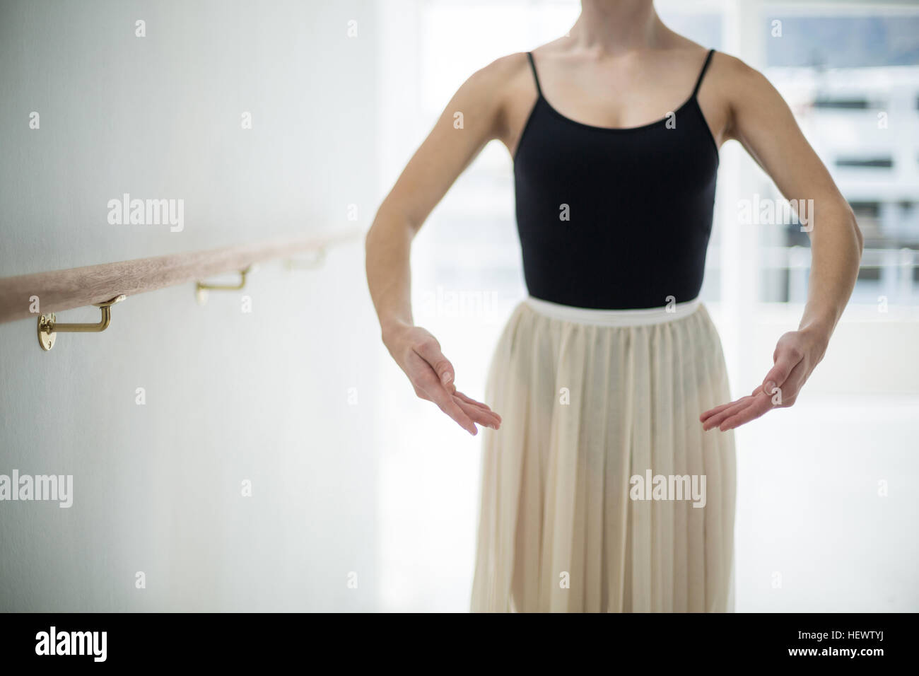 Mid section of ballerina practicing a ballet dance in ballet studio ...