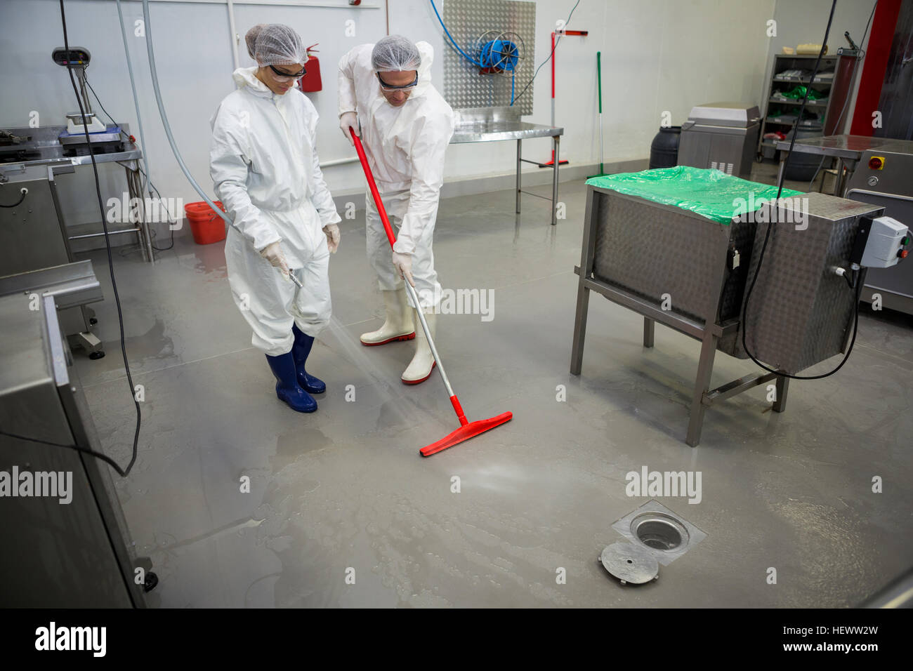 Staff cleaning the floor at meat factory Stock Photo - Alamy