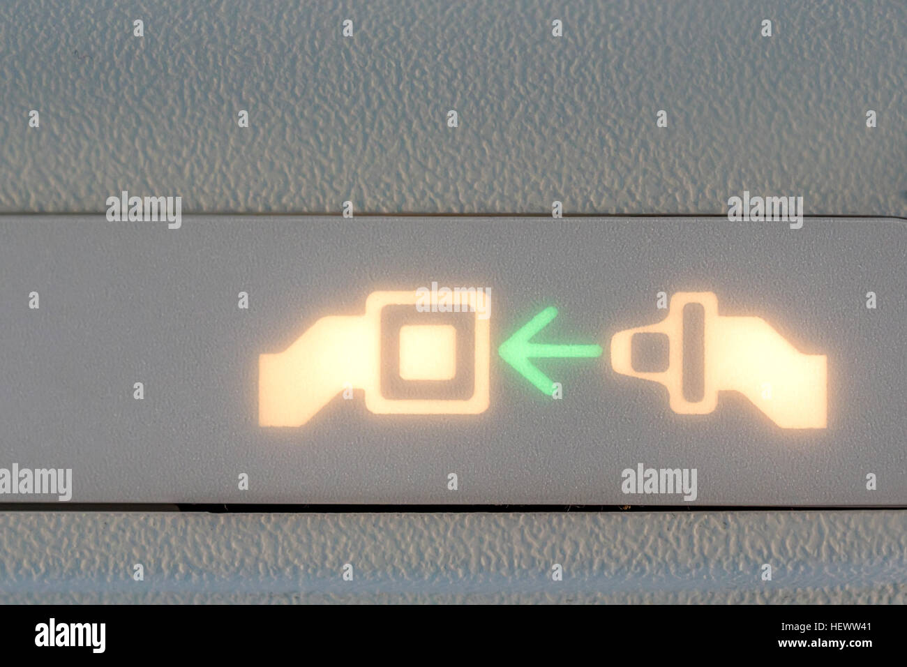 Fasten seat belt indicator inside an passenger airplane cabin closeup ...