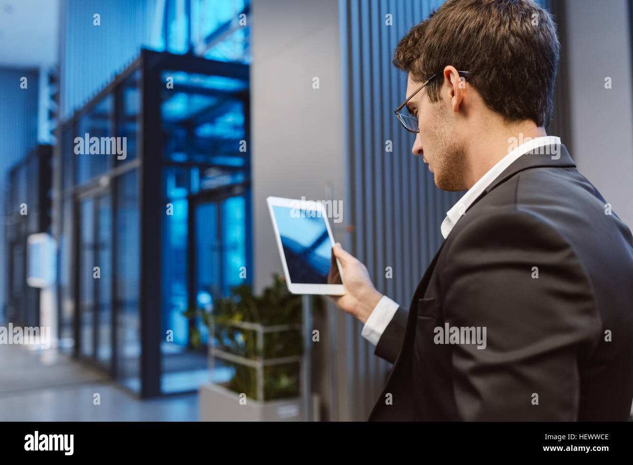 Back view of Business man in suit and glasses with laptop computer in ...