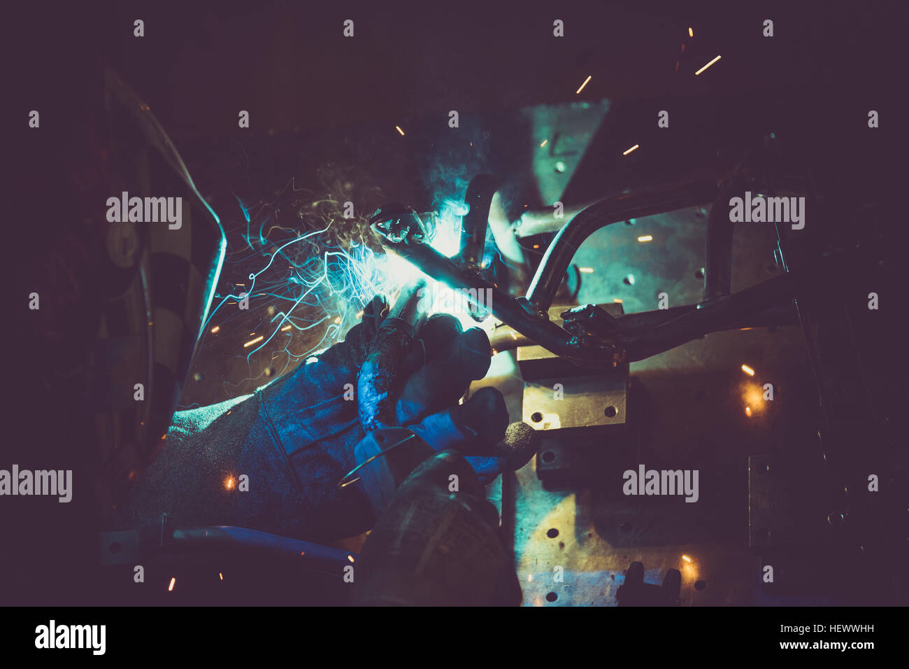 Welding steel material in an industrial environment with hot sparks ...