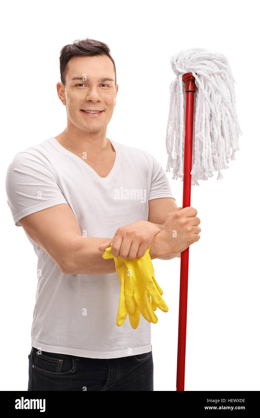 Young man with a mop and a pair of cleaning gloves isolated on white ...