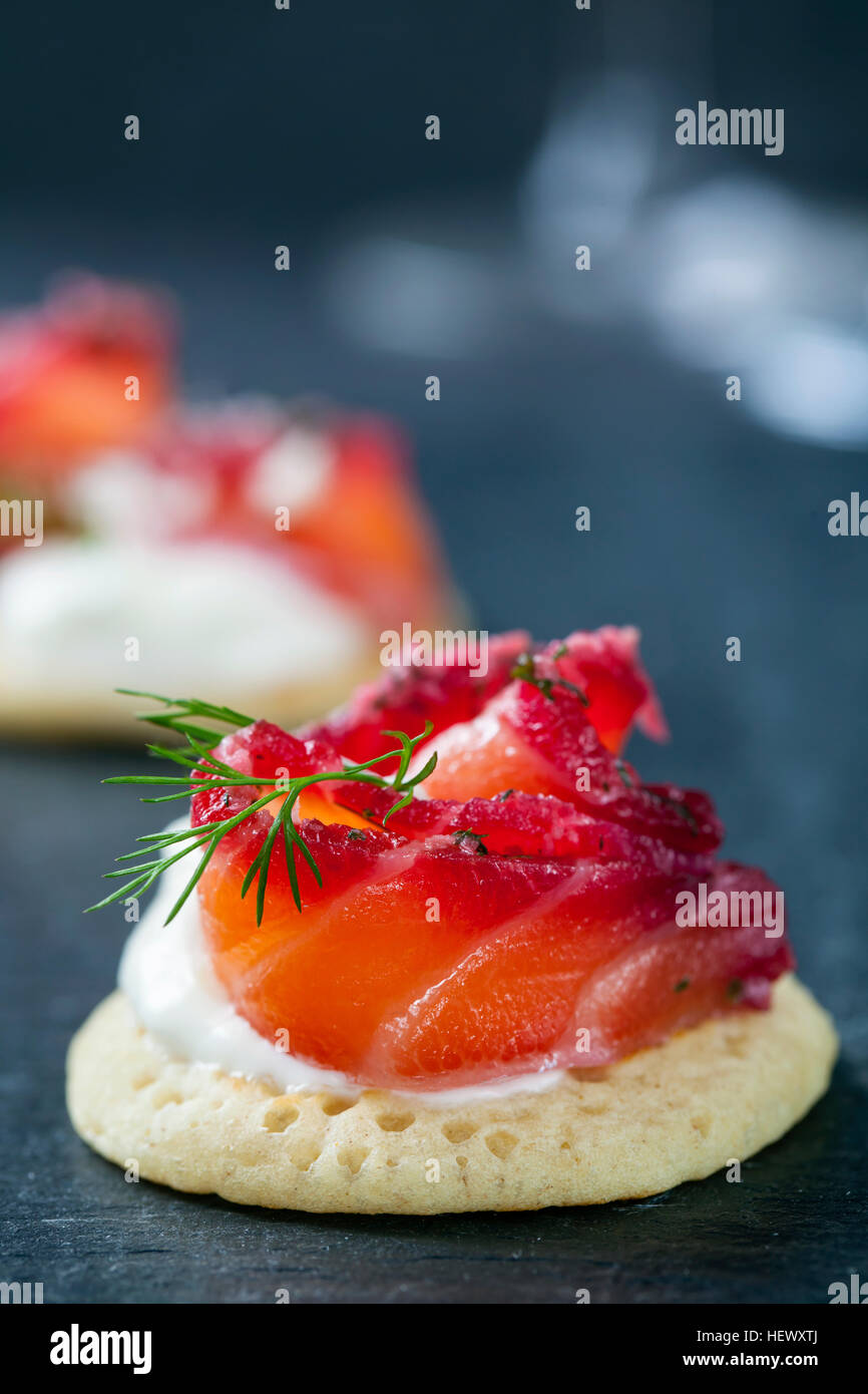 Party blinis with beetroot cured salmon, cream and horseradish Stock ...