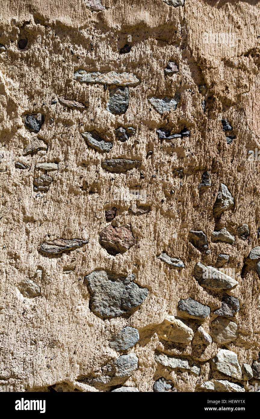 The detail of a sand and stone mud brick wall in an ancient desert ...