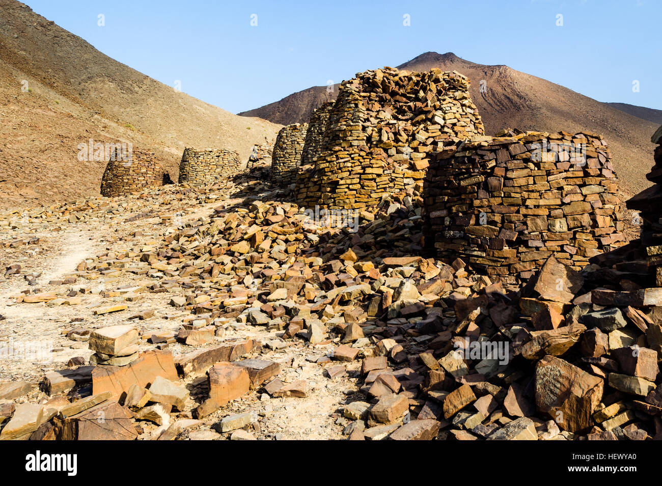Ancient handmade stone burial mounds and tombs atop a desert ridge ...