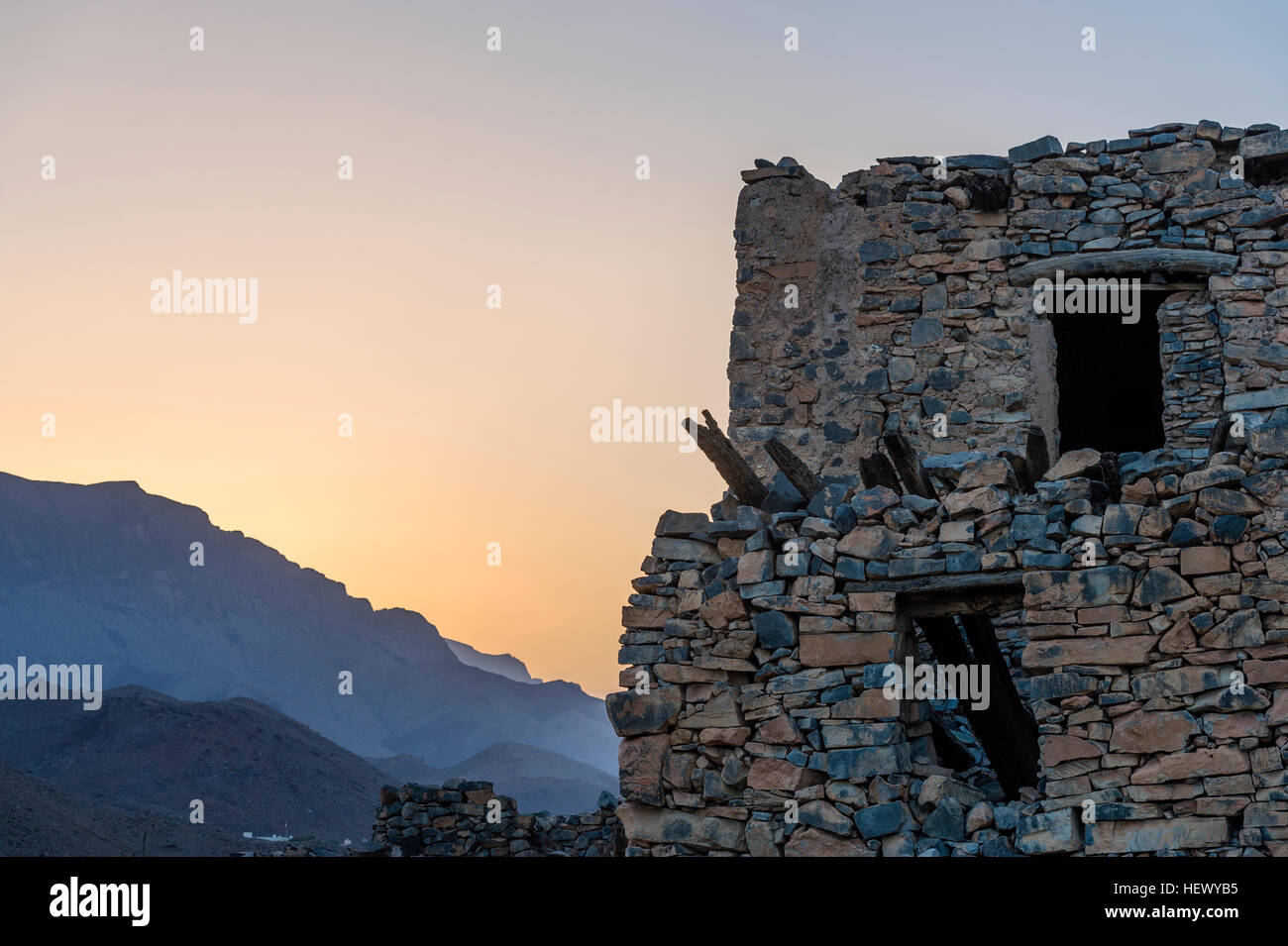 An ancient handmade stone building wall in an abandoned desert village ...