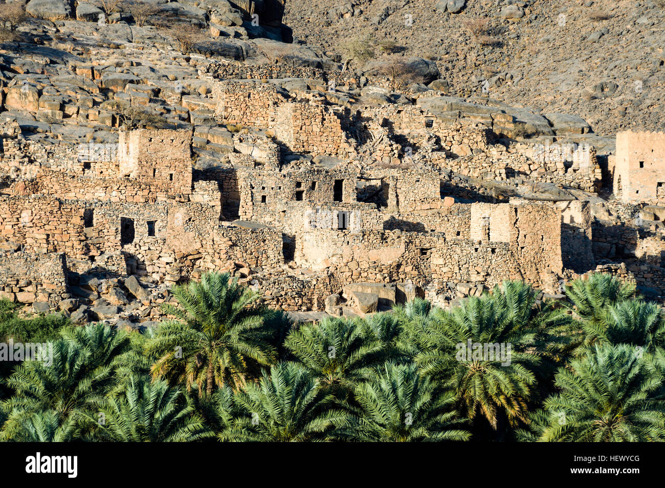 An ancient abandoned stone village on a desert mountainside above an ...