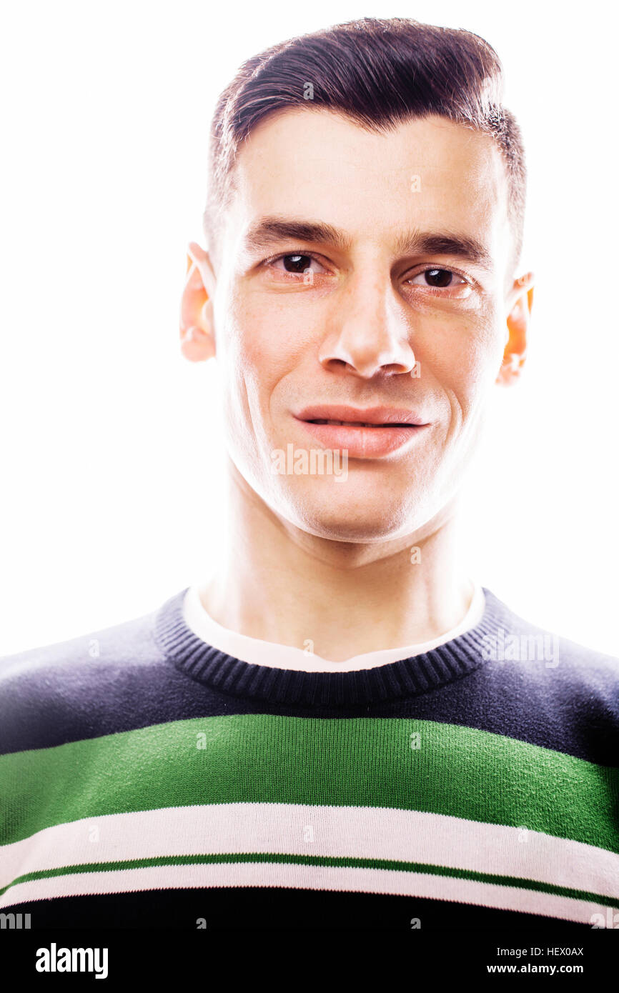 Portrait of a smart serious young man standing against white bac Stock ...