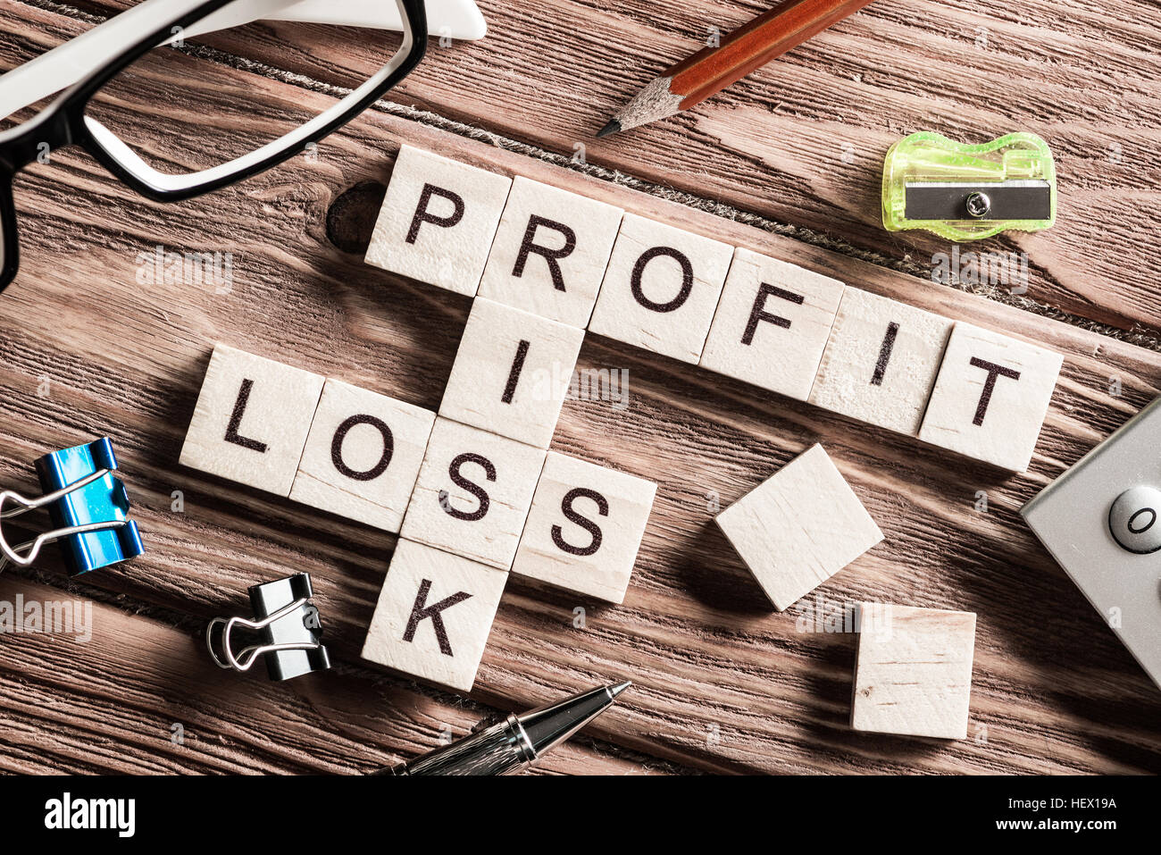 Profit loss and risk words on workplace collected of wooden cubes Stock ...