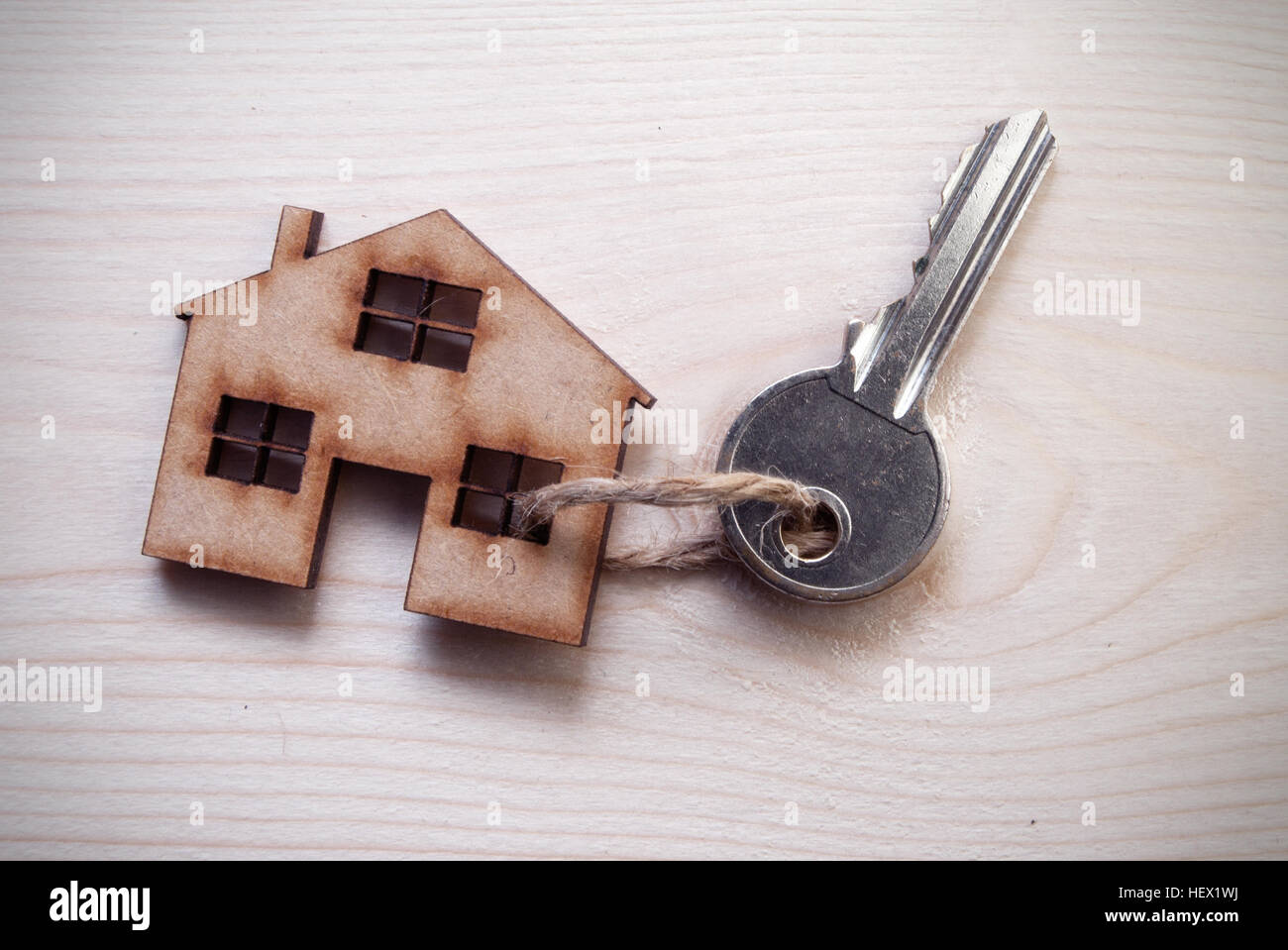 Key attached to a small house Stock Photo - Alamy