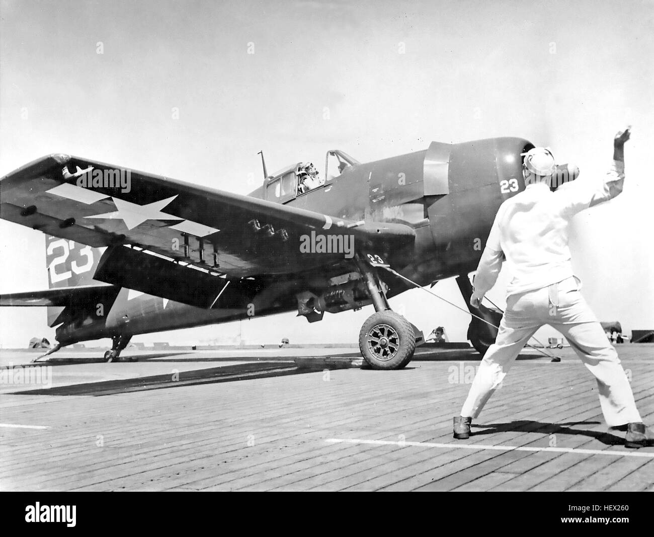 U.S. NAVY GRUMANN F6F-5 HELLCAT with loaded bomb preparing to launch ...