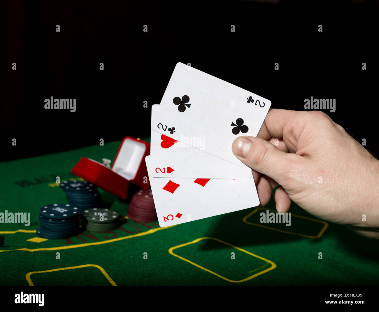poker on a green table background, man holding losing combination of ...