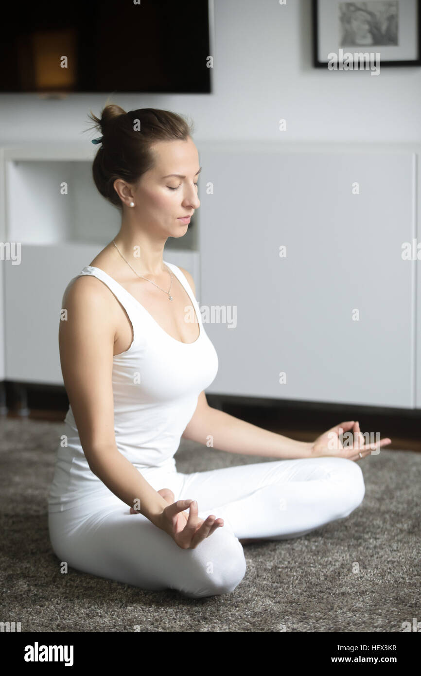 Portrait of an attractive woman at Lotus Pose Stock Photo - Alamy