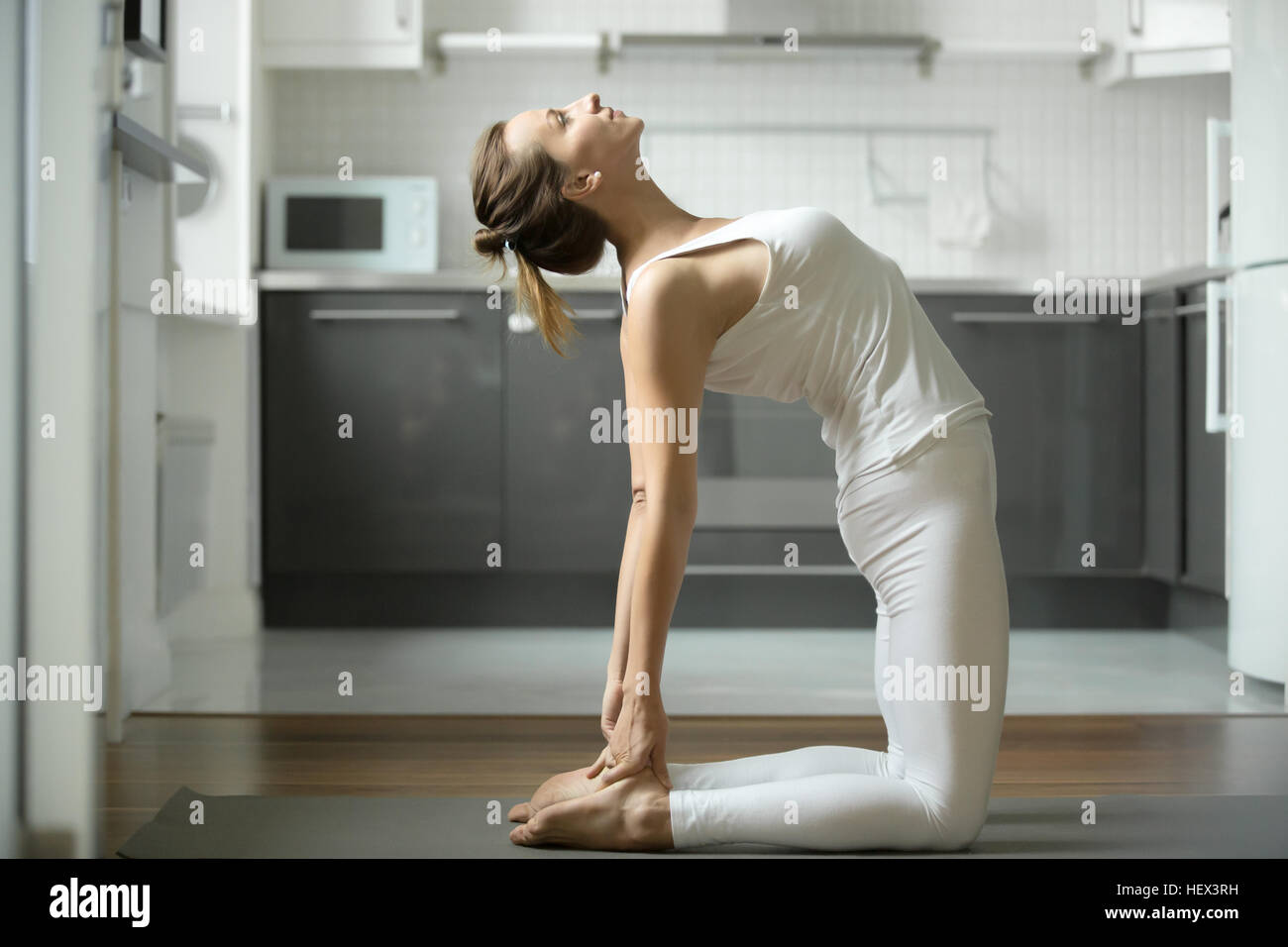 Woman stretching in Camel exercise Stock Photo - Alamy