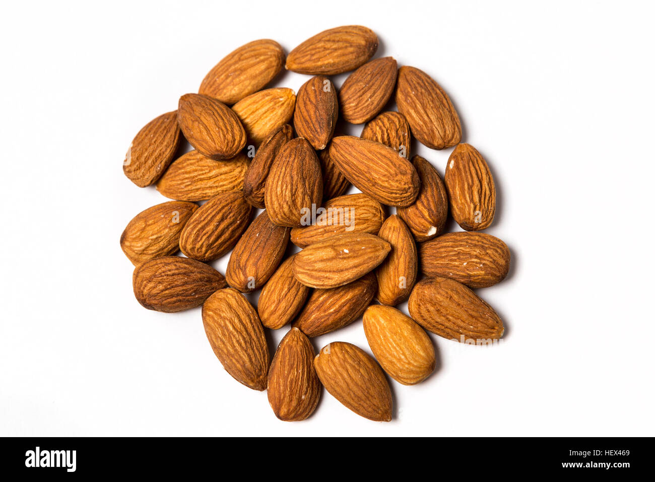 Pile of unshelled almonds isolated on white background Stock Photo - Alamy
