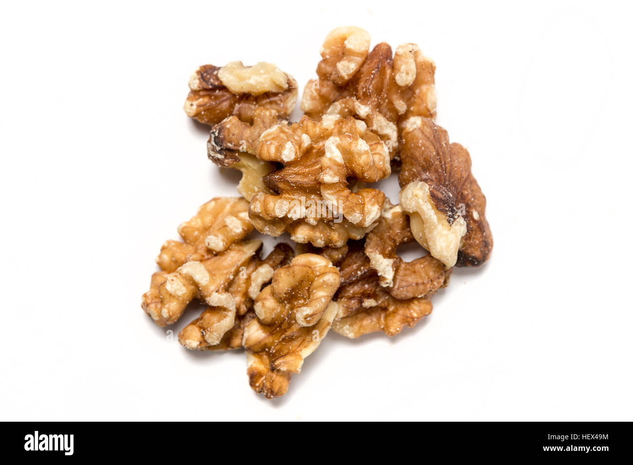 Stack of unshelled walnuts isolated on white background Stock Photo - Alamy