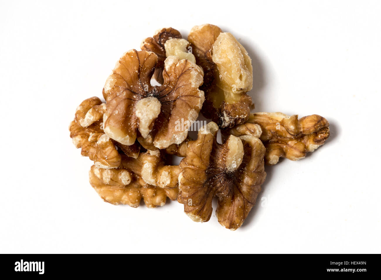 Stack of unshelled walnuts isolated on white background Stock Photo - Alamy