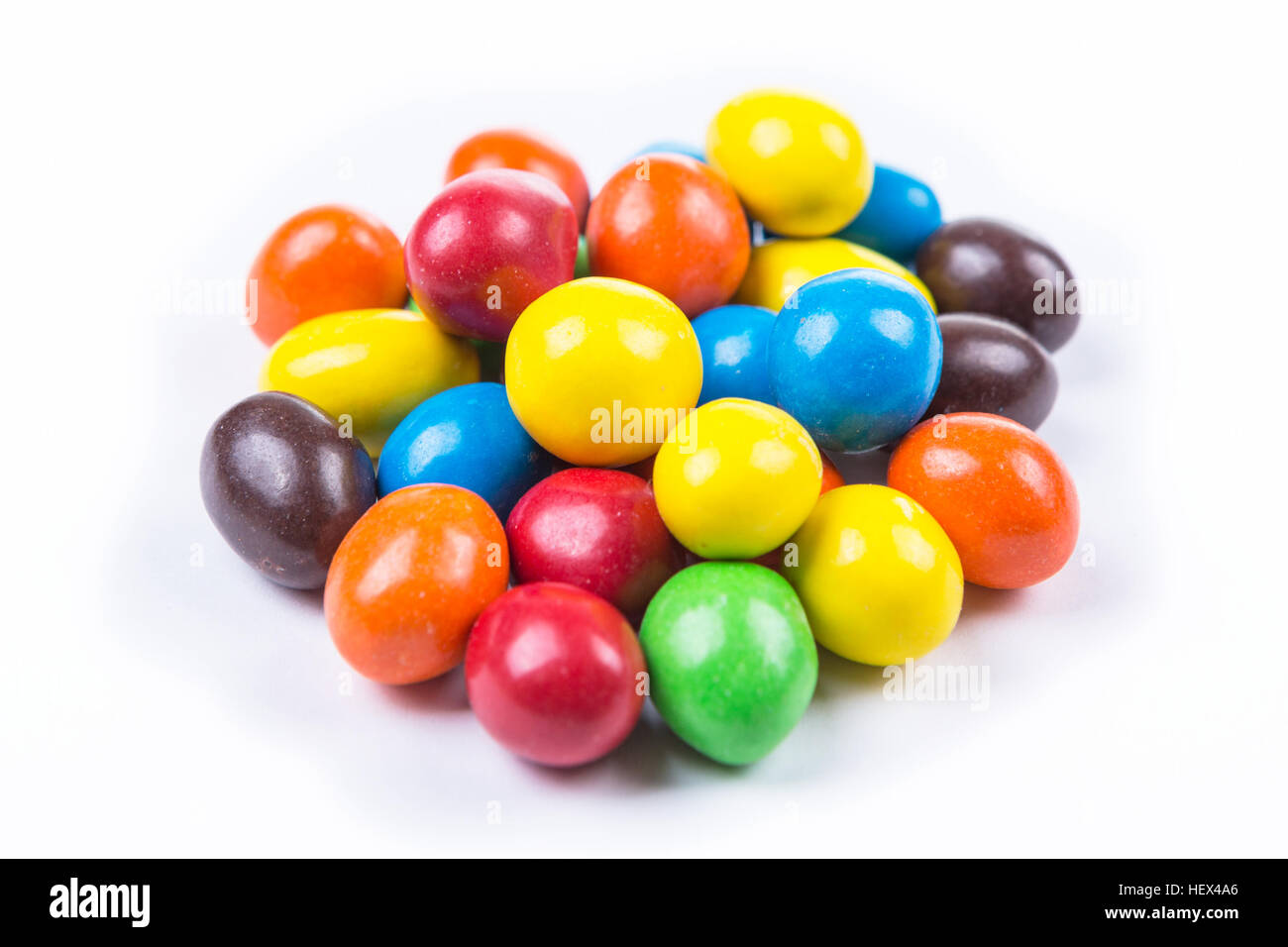 Chocolate covered peanuts with a candy shell isolated on white ...
