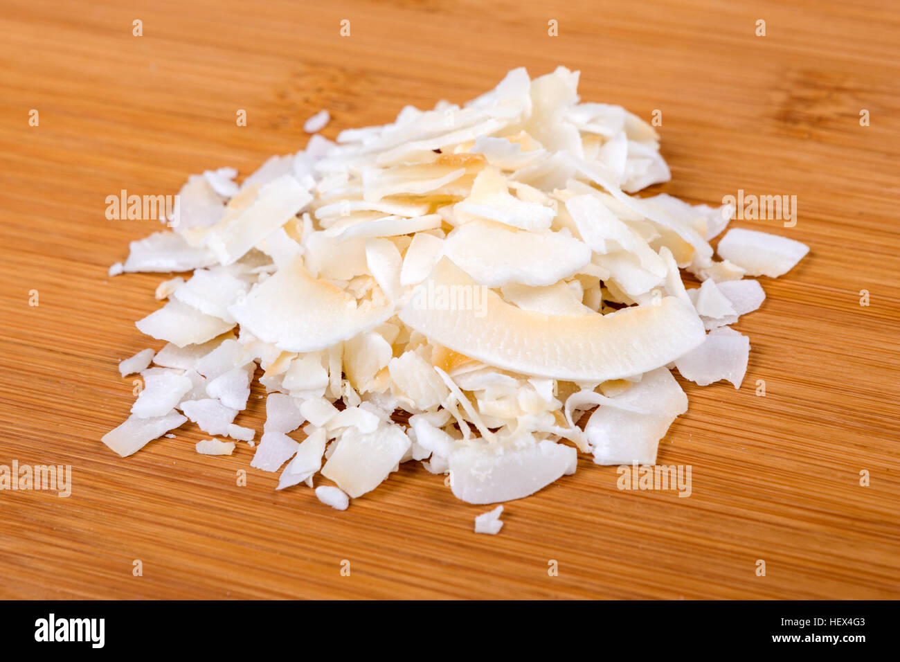 Roasted shaved coconut isolated on wood background Stock Photo - Alamy