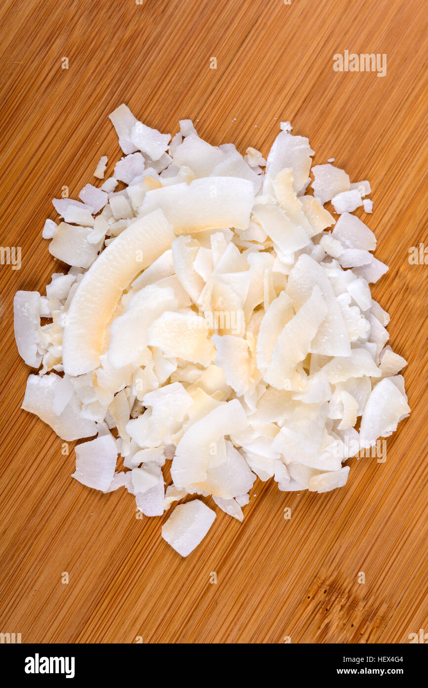 Roasted shaved coconut isolated on wood background Stock Photo - Alamy