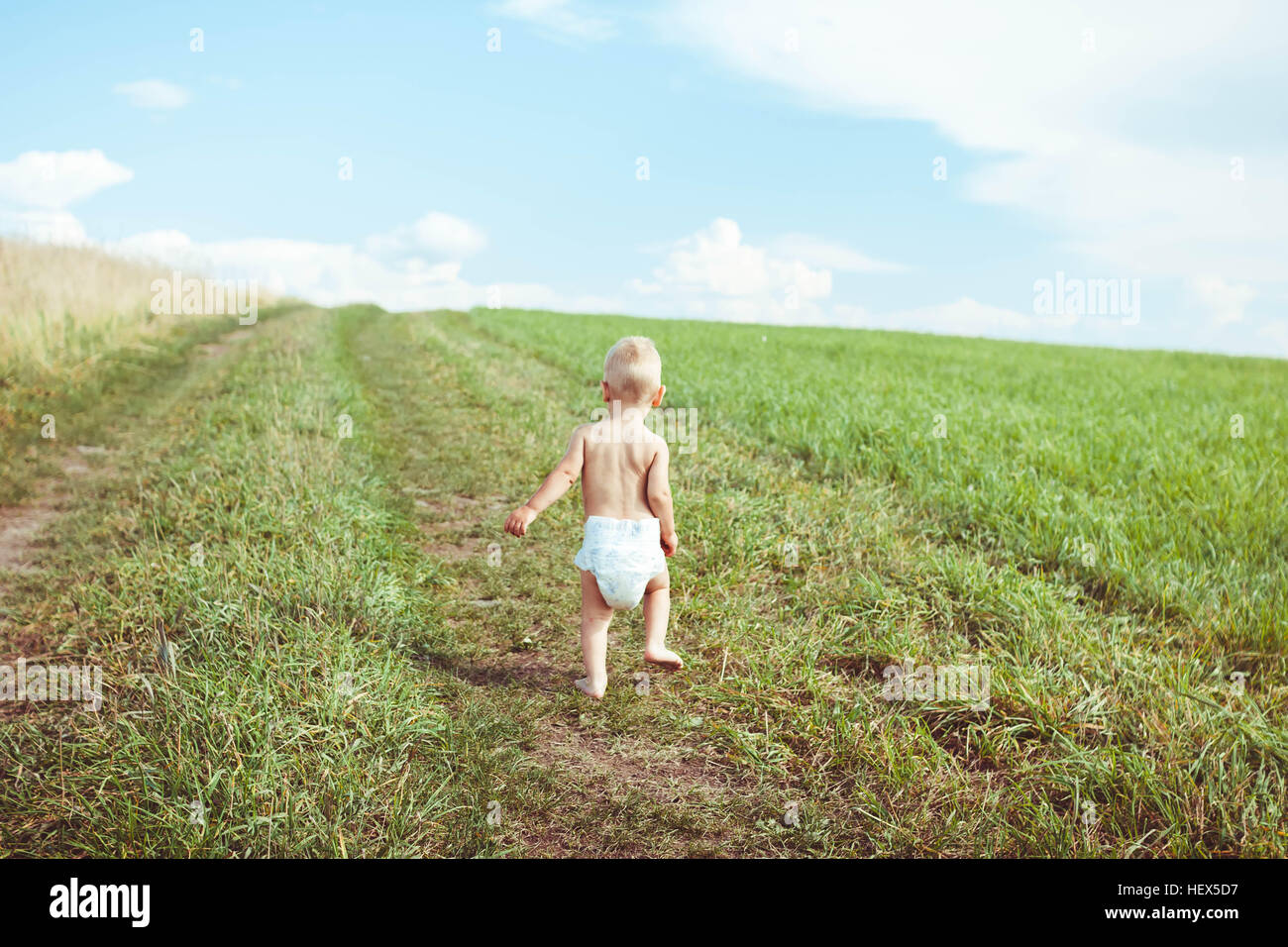 child running in a field Stock Photo - Alamy