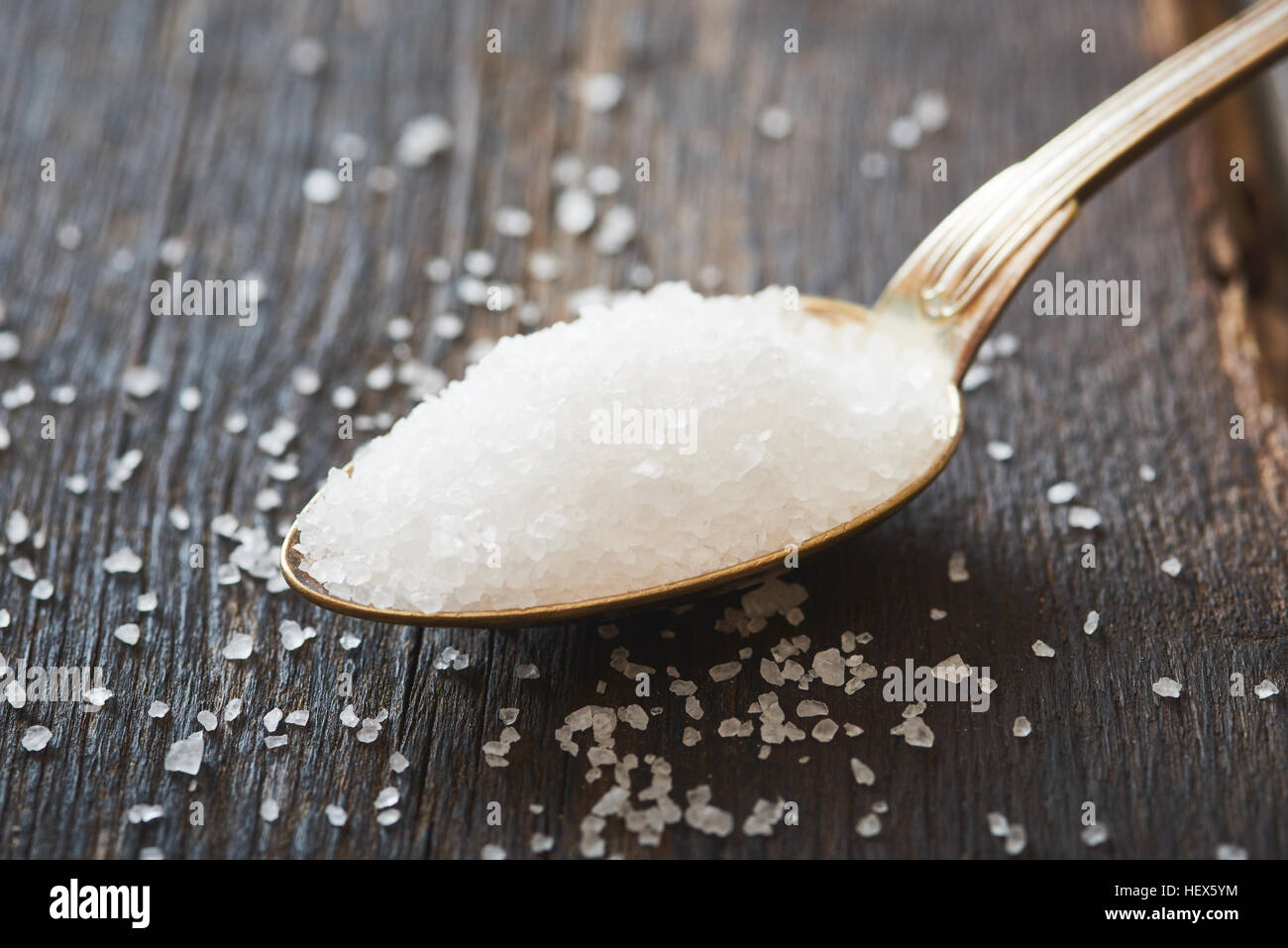 Sea salt in a spoon on wooden table Stock Photo - Alamy