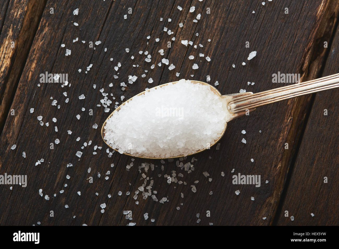 Sea salt in a spoon on wooden table Stock Photo - Alamy