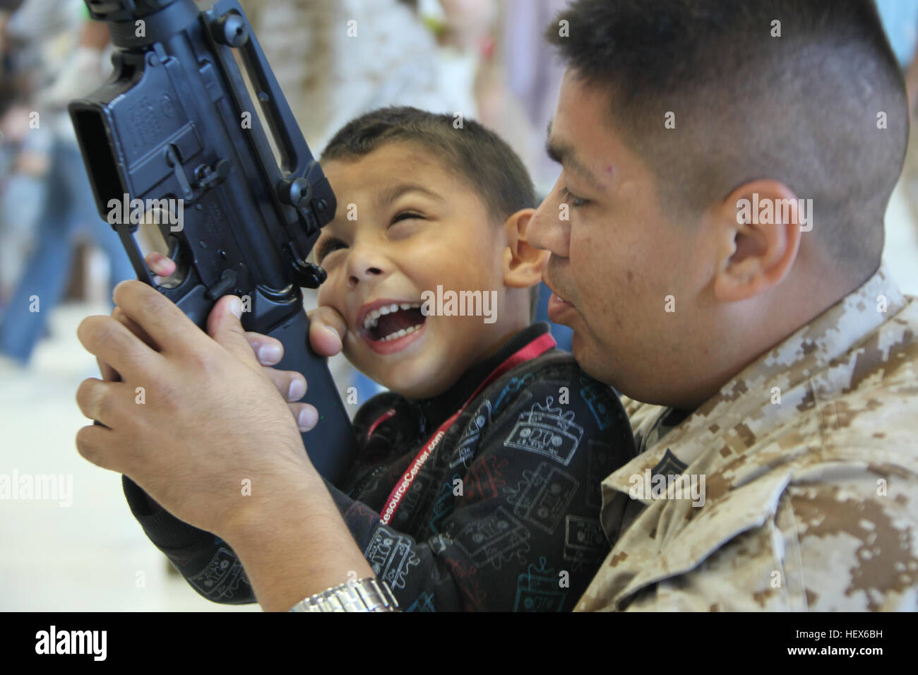 Joel Langley, son of Staff Sgt. Joe Langley, squints through the sights ...