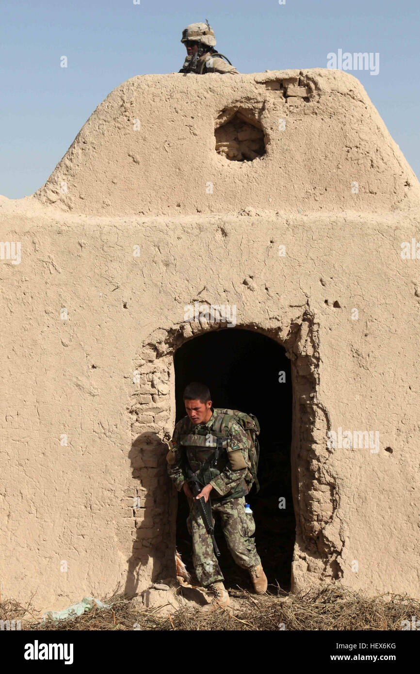A U.S. Marine, top, and an Afghan National Army (ANA) soldier clear a ...