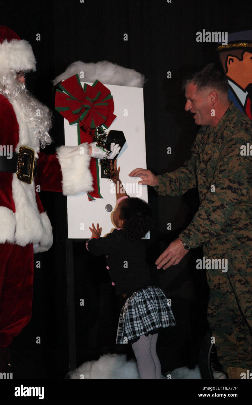 Tahtiana Loper, 3, helps Santa Claus and Col. Philip J. Zimmerman , the ...