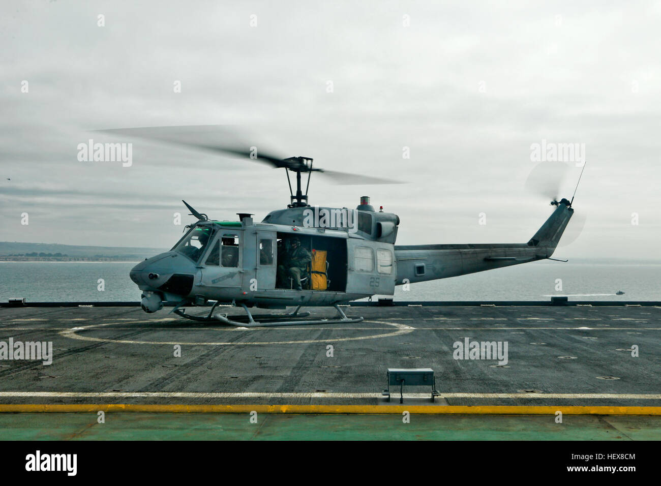 A UH-1N Huey lands on the deck of USNS Sgt. William Button near Camp ...