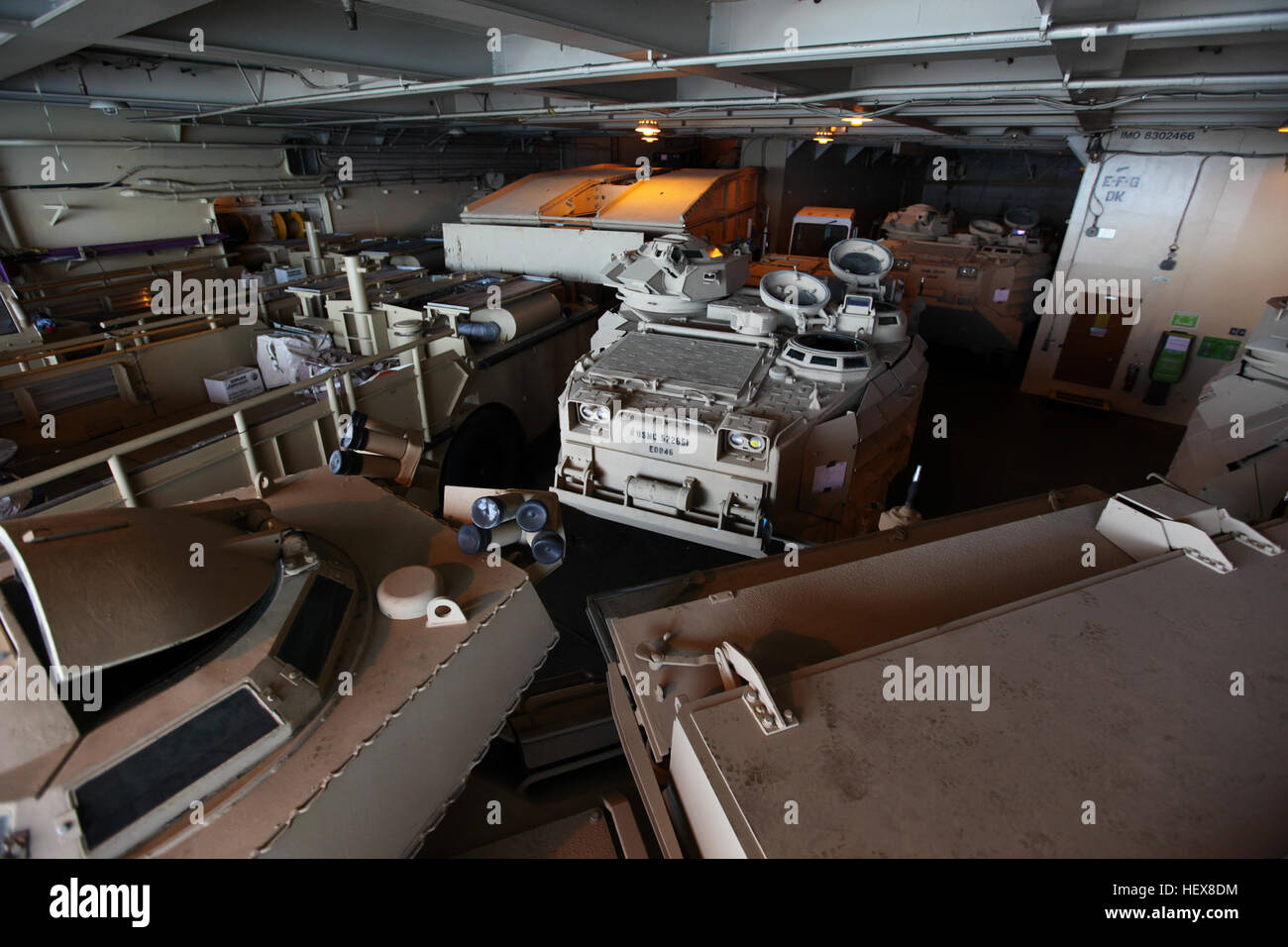 U.S. Navy sailors and Marines unload equipment from USNS Sgt. William ...